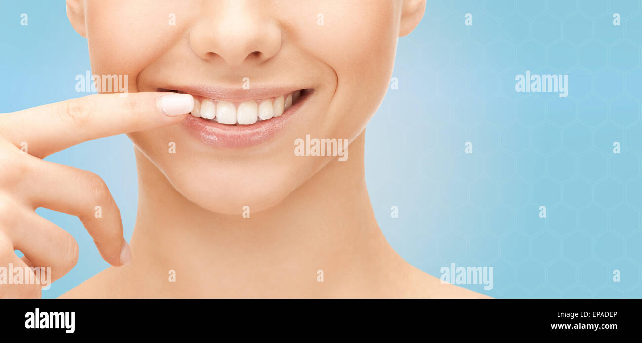 close up of smiling woman face pointing to teeth Stock Photo - Alamy