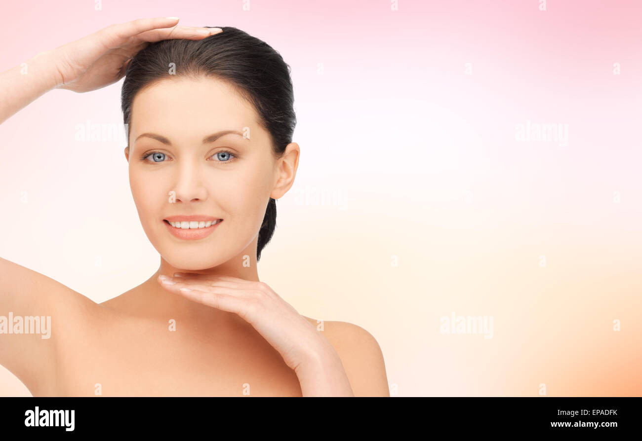 beautiful young woman touching her face and chin Stock Photo - Alamy