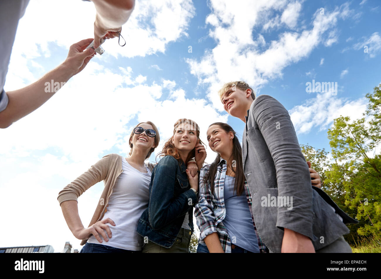 group of happy friends with camera taking picture Stock Photo - Alamy