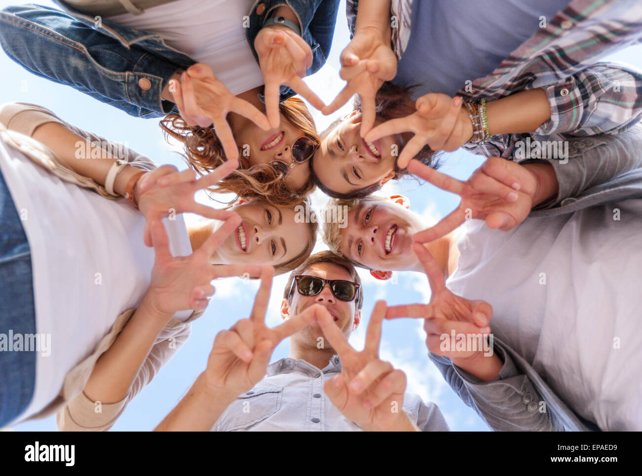 group of teenagers showing finger five Stock Photo - Alamy