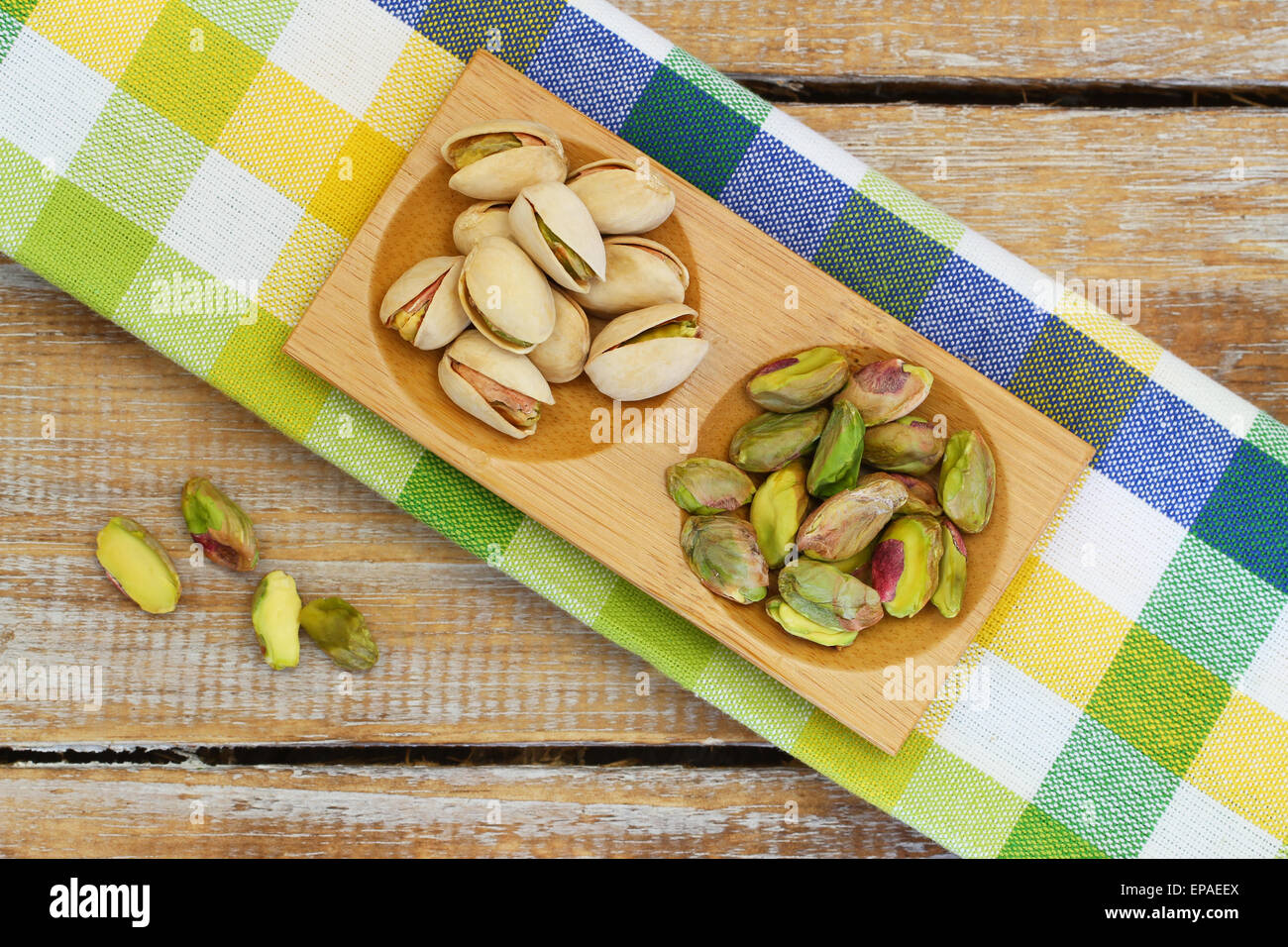 Pistachio nuts with and without shell on checkered cloth Stock Photo ...