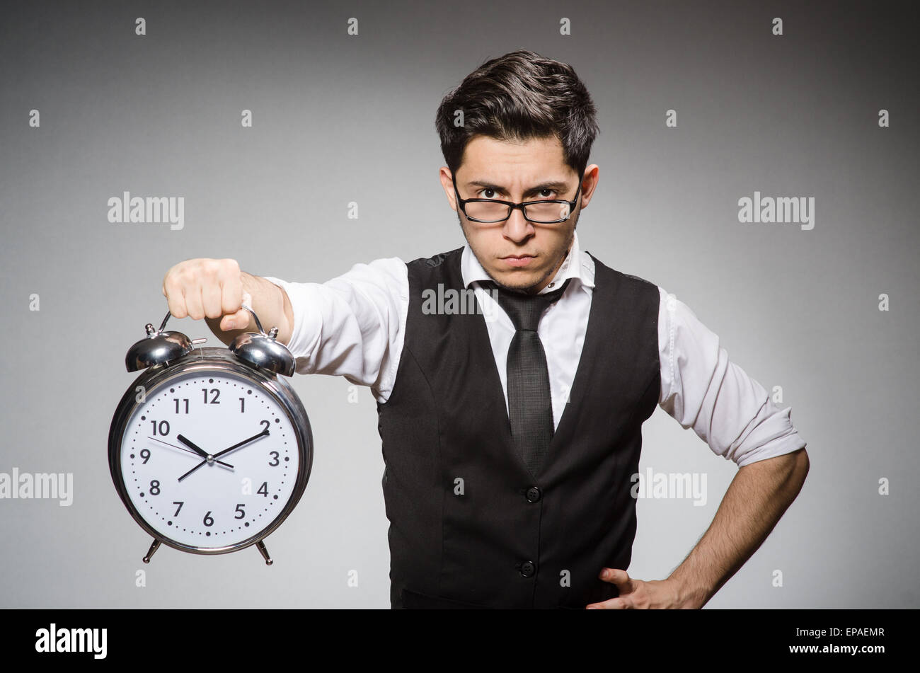 Businessman with clock in time concept Stock Photo - Alamy