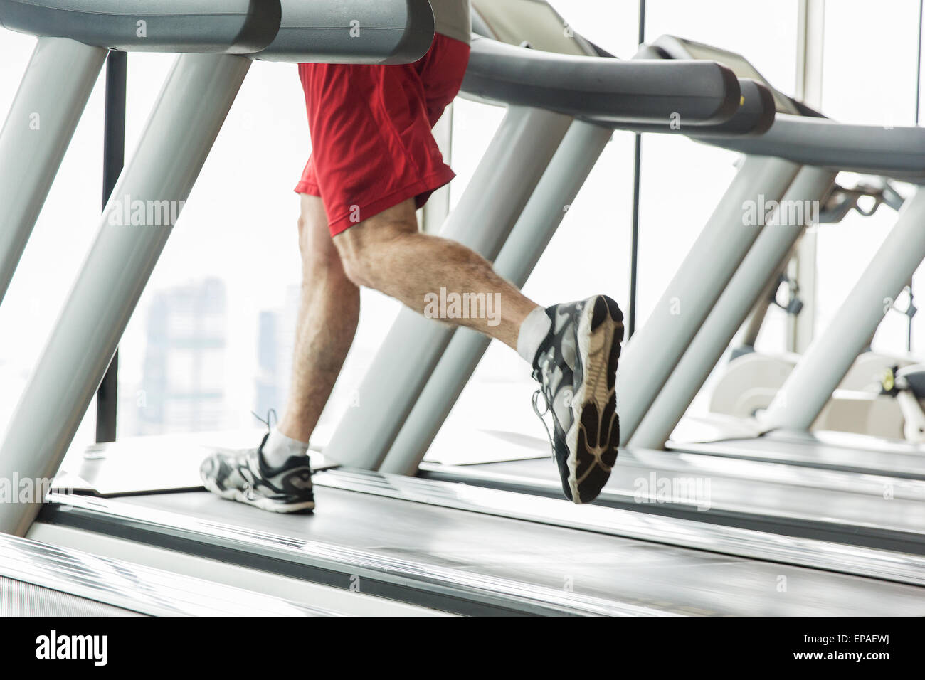 close up of male legs running on treadmill in gym Stock Photo - Alamy