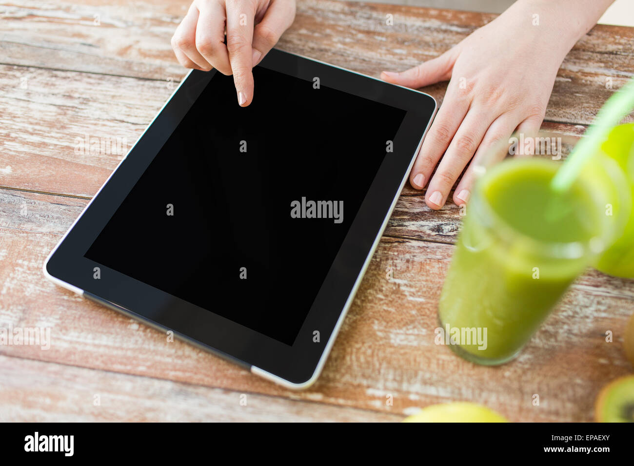 close up of woman hands tablet pc and fruit juice Stock Photo - Alamy