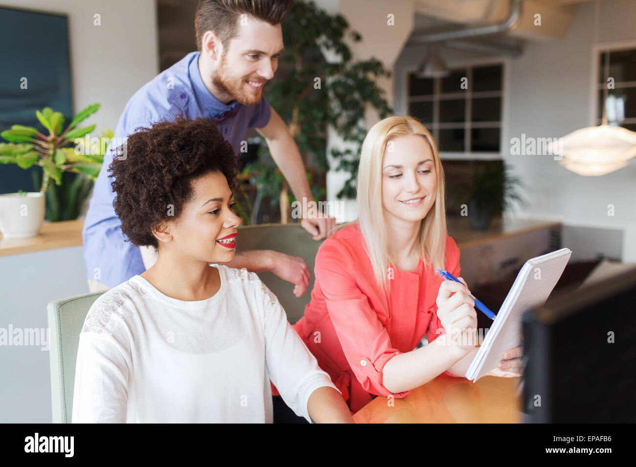 happy creative team with computer in office Stock Photo - Alamy