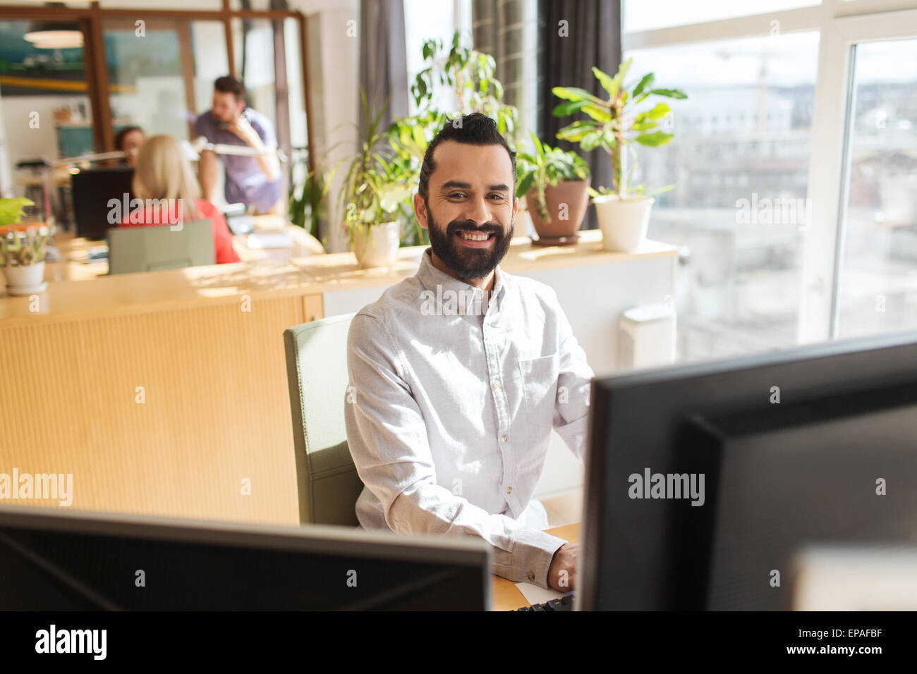 happy creative male office worker with computer Stock Photo - Alamy