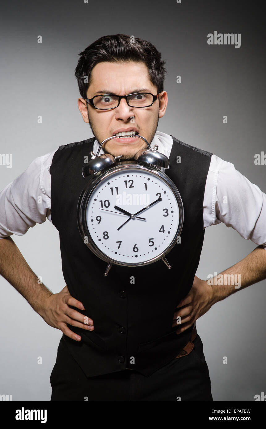 Businessman with clock in time concept Stock Photo - Alamy