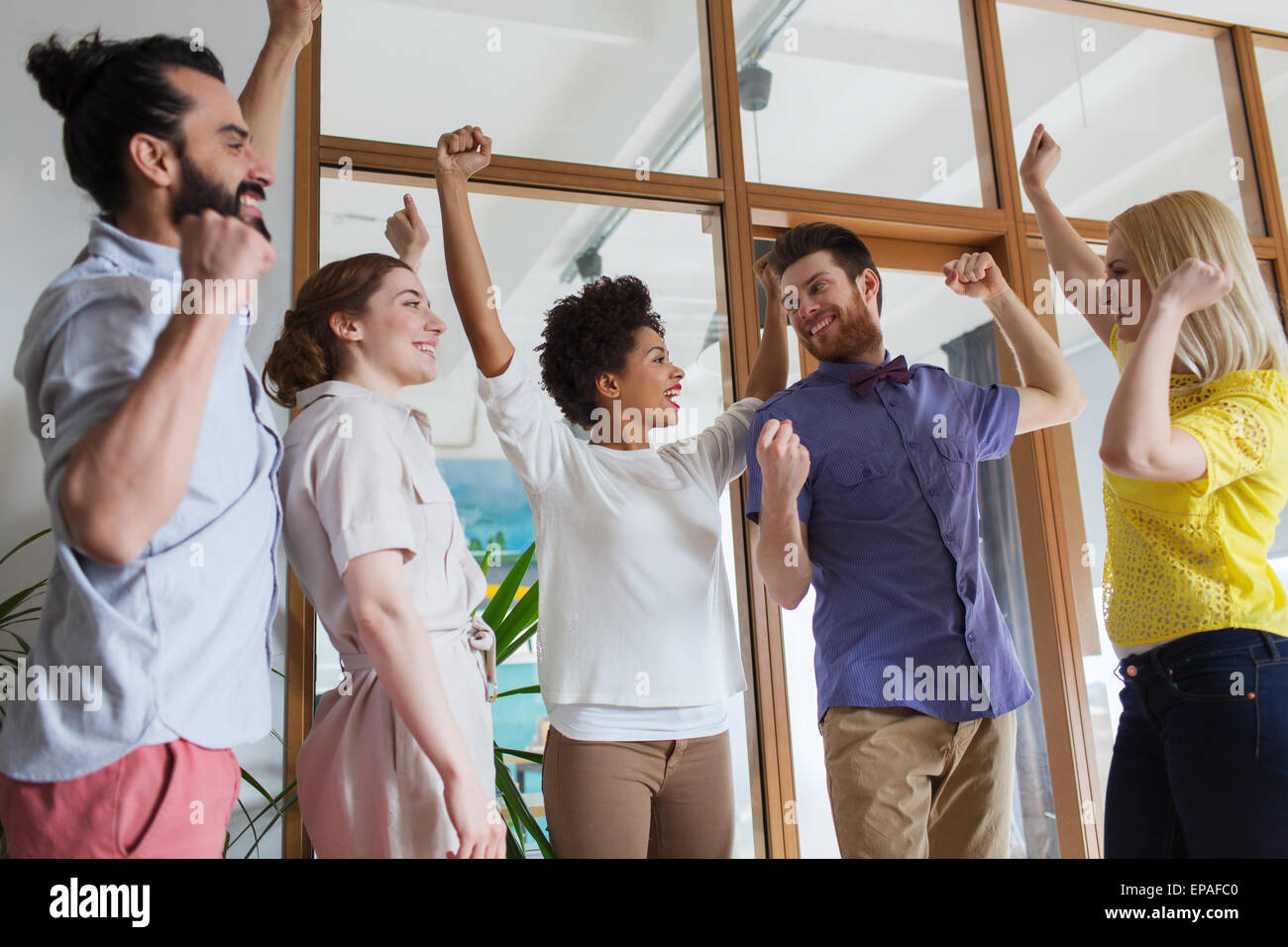 happy creative team celebrating victory in office Stock Photo - Alamy