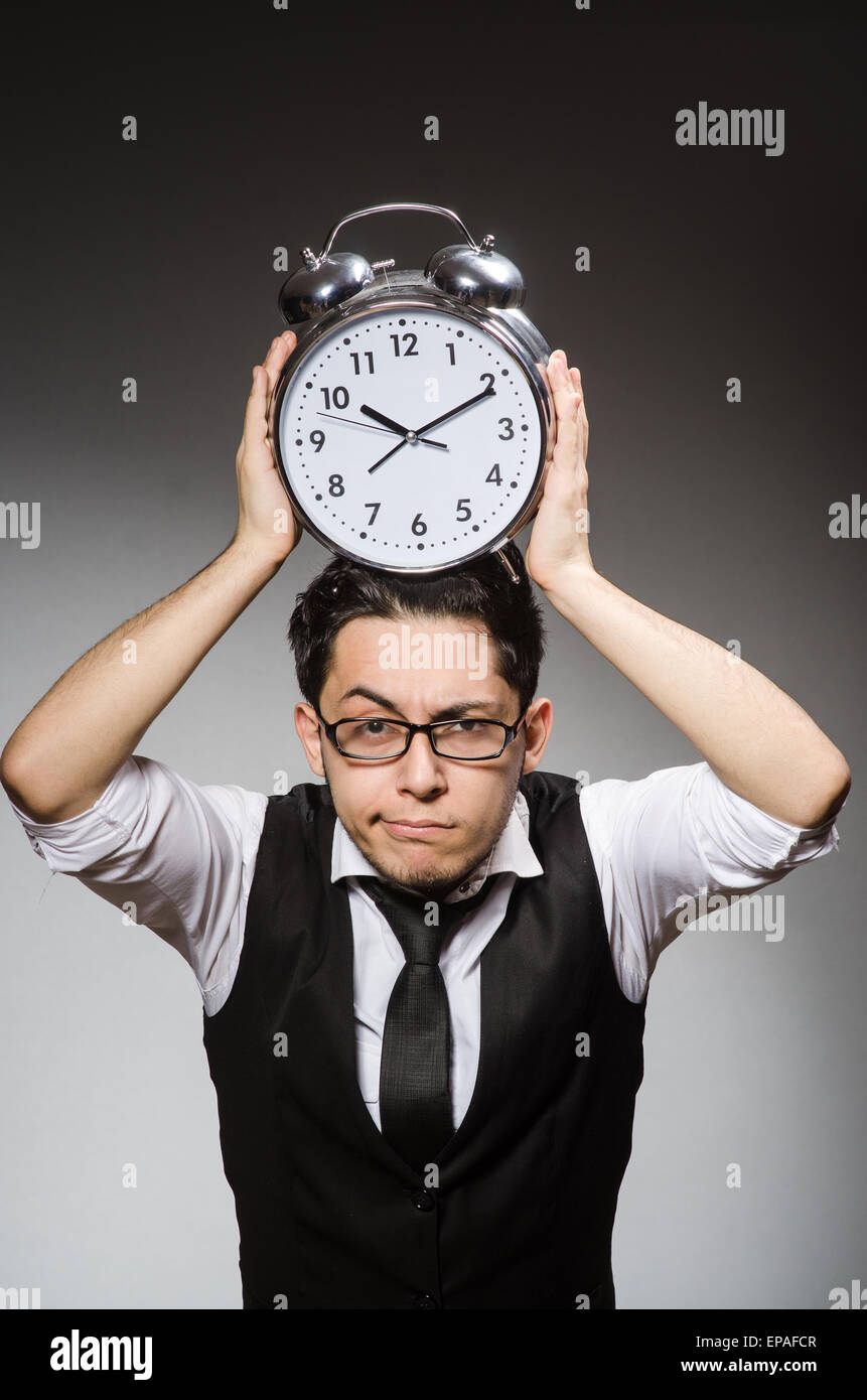 Businessman with clock in time concept Stock Photo - Alamy