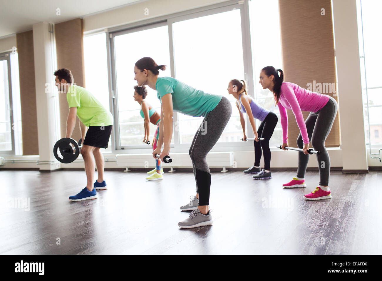 group of people exercising with barbell in gym Stock Photo - Alamy