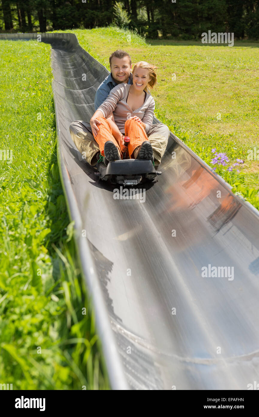 Happy Couple Enjoying Alpine Coaster Luge Stock Photo - Alamy