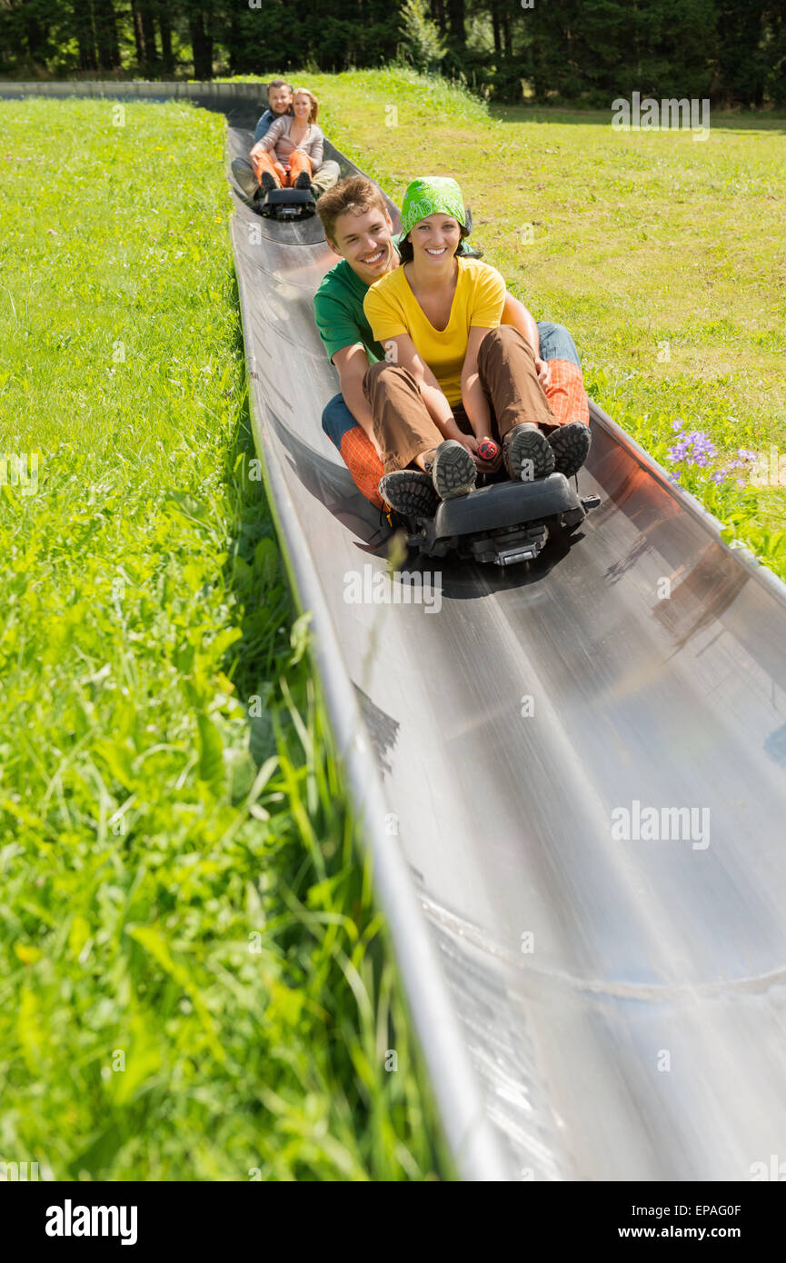 Happy Couples Enjoying Alpine Coaster Luge Stock Photo - Alamy