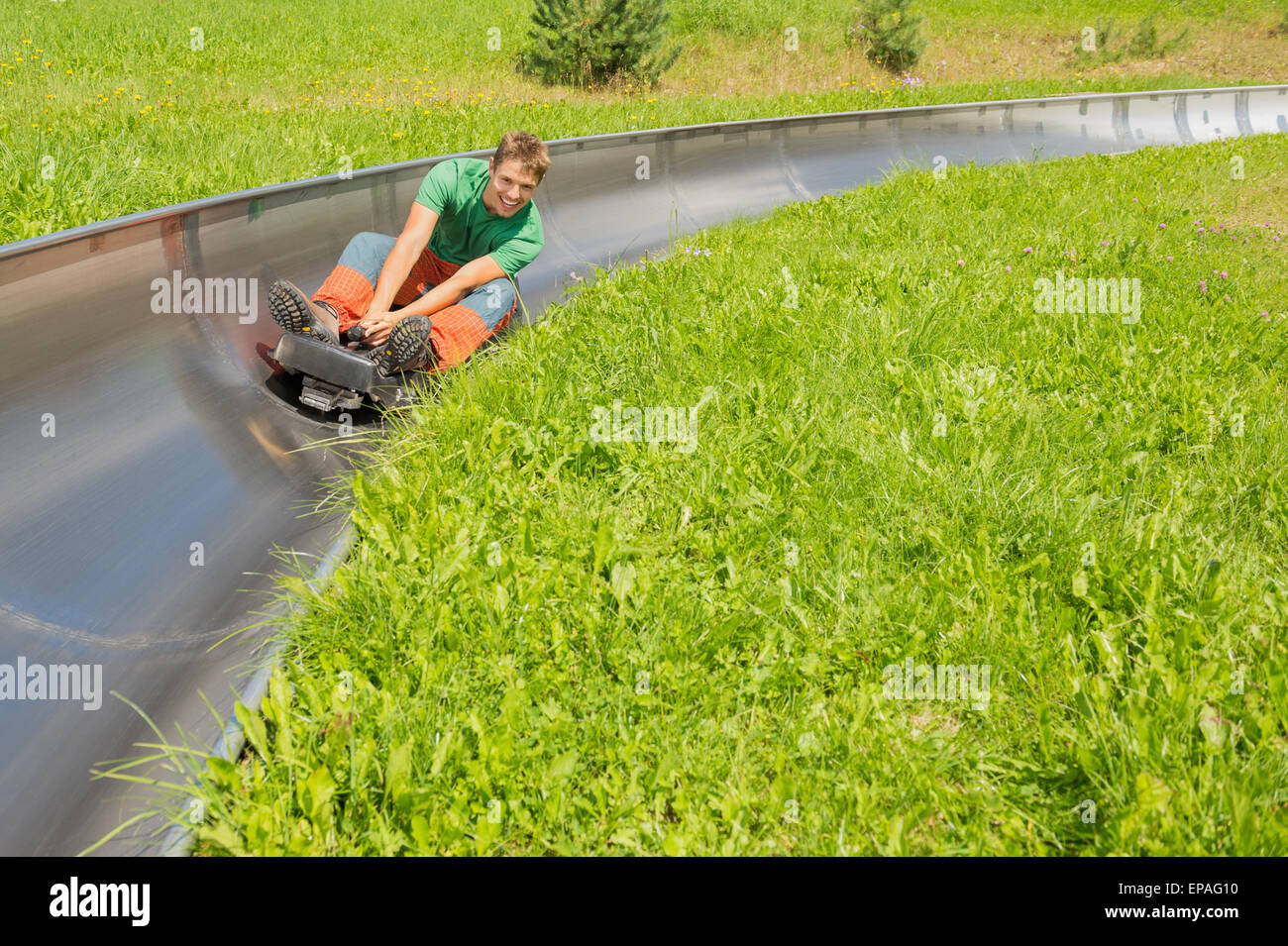 Happy Man Enjoying Alpine Coaster Luge Stock Photo - Alamy