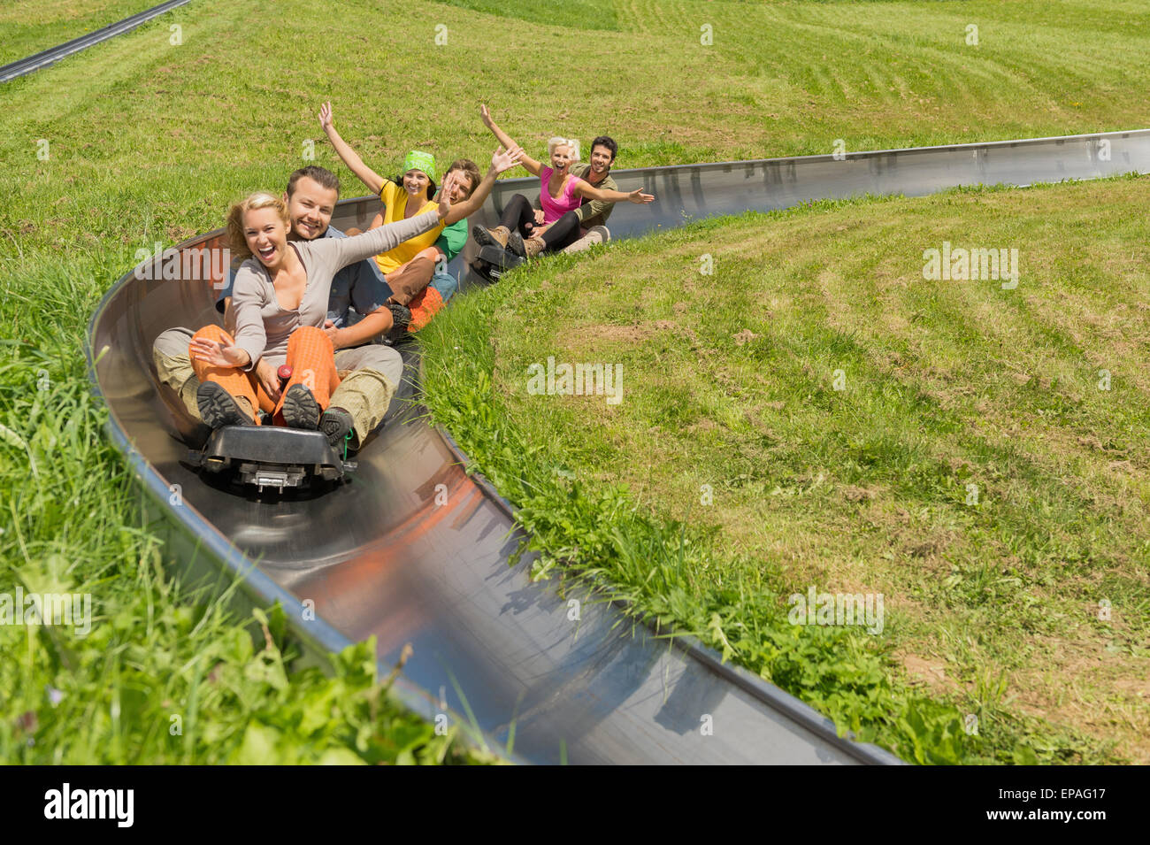 Happy Couples Enjoying Summer Sledge Stock Photo - Alamy