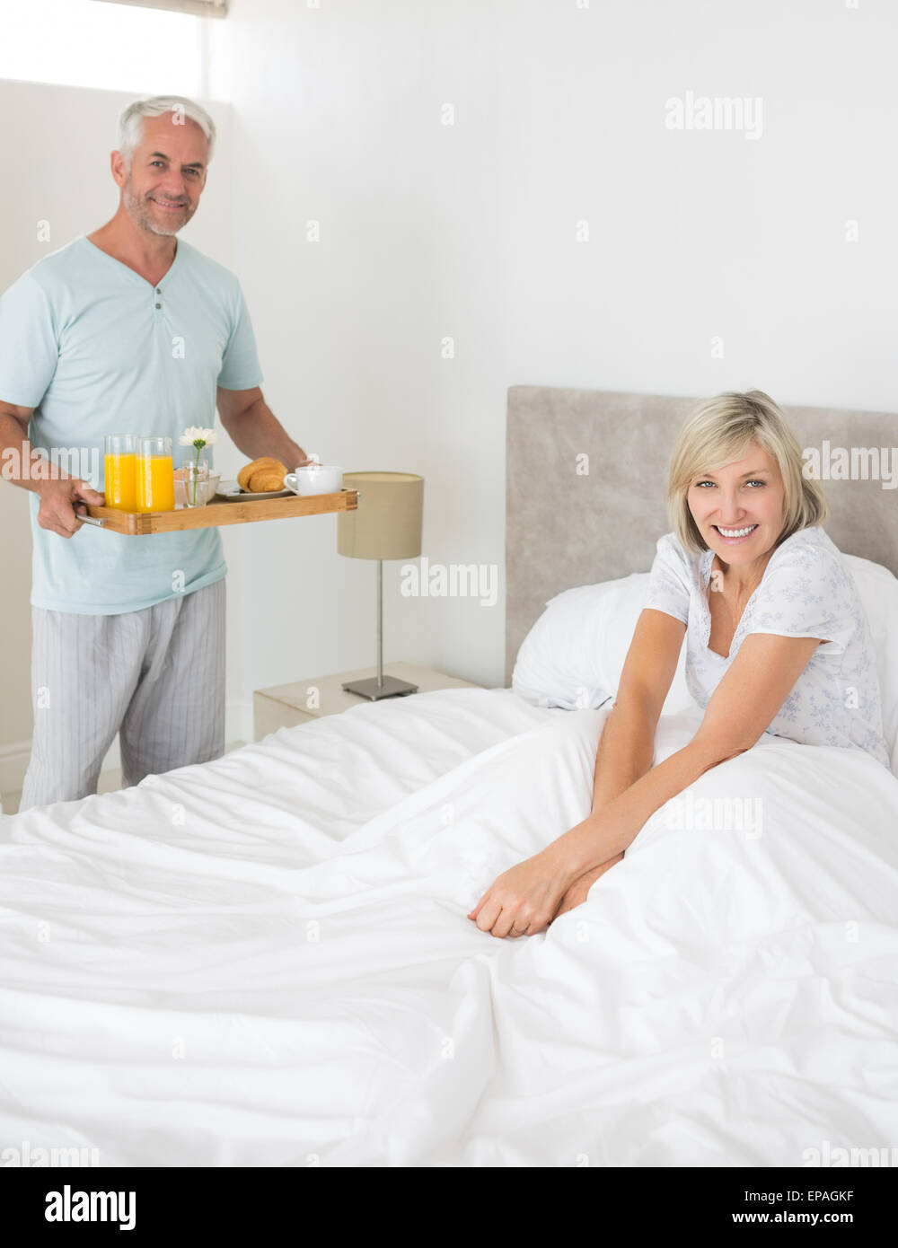 Man serving woman breakfast in bed Stock Photo - Alamy