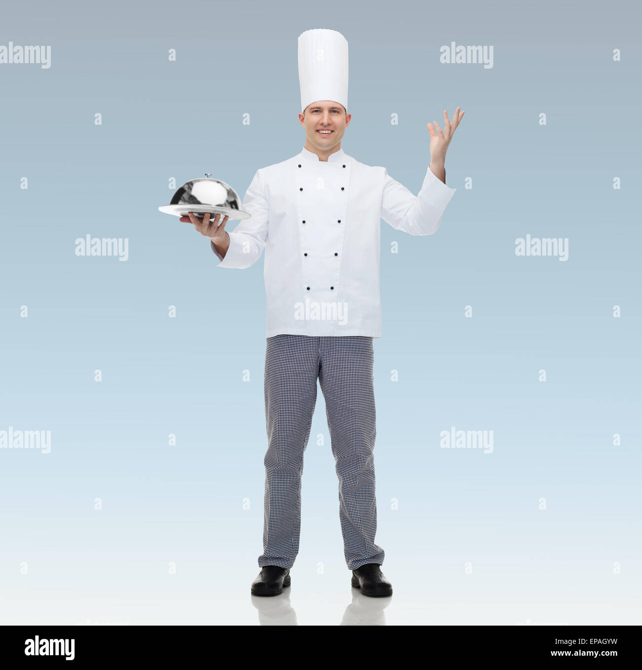 happy male chef cook holding cloche Stock Photo - Alamy