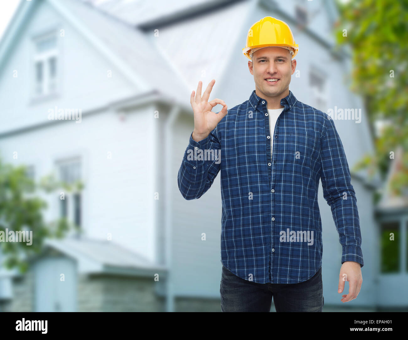 smiling male builder in helmet showing ok sign Stock Photo - Alamy