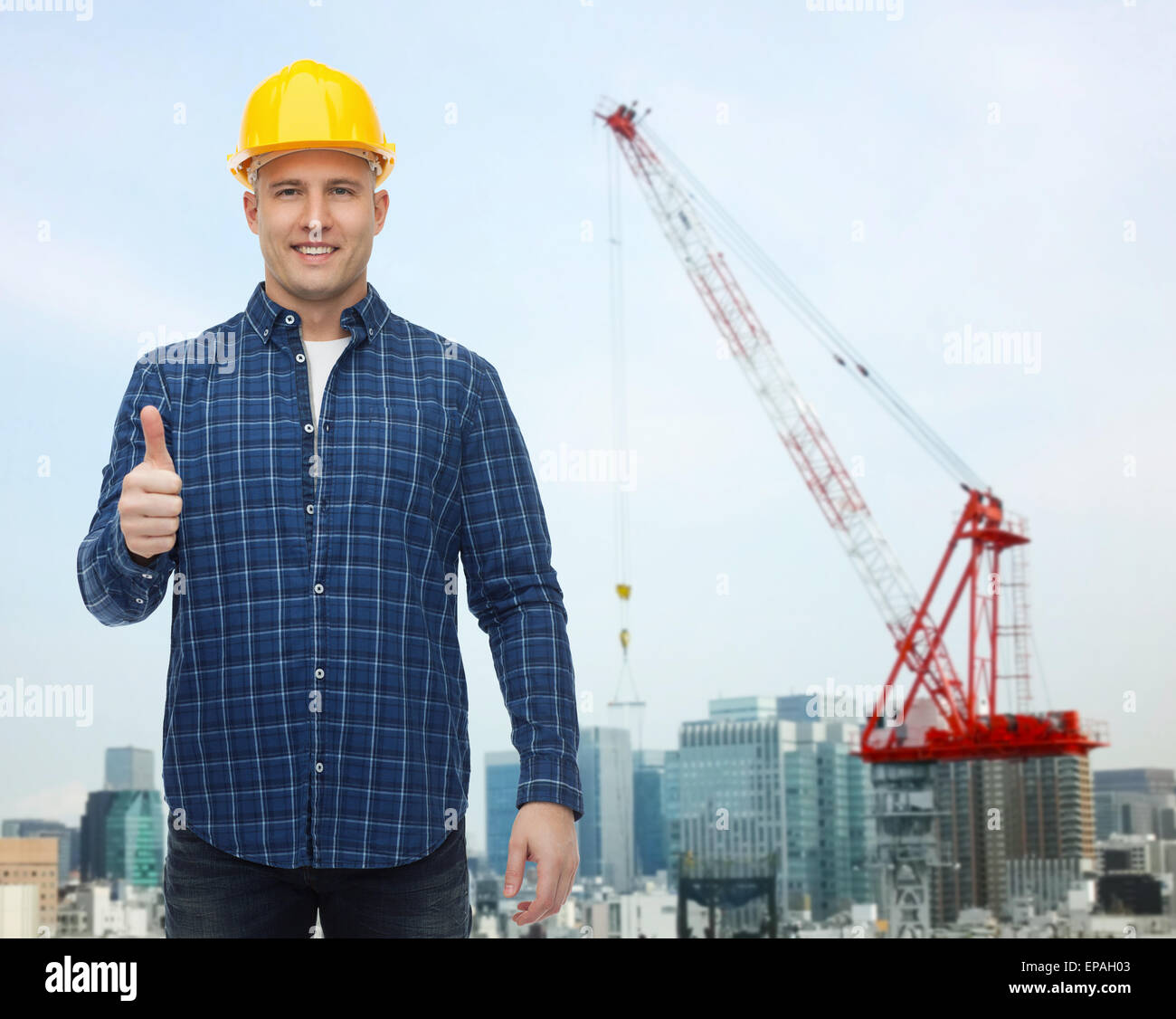 smiling male builder in helmet showing thumbs up Stock Photo - Alamy
