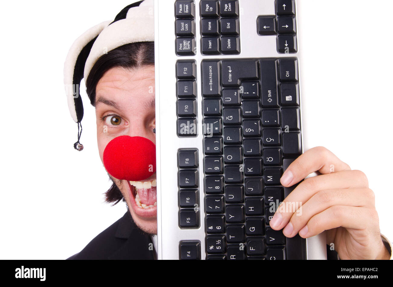 Funny clown with keyboard isolated on white Stock Photo - Alamy