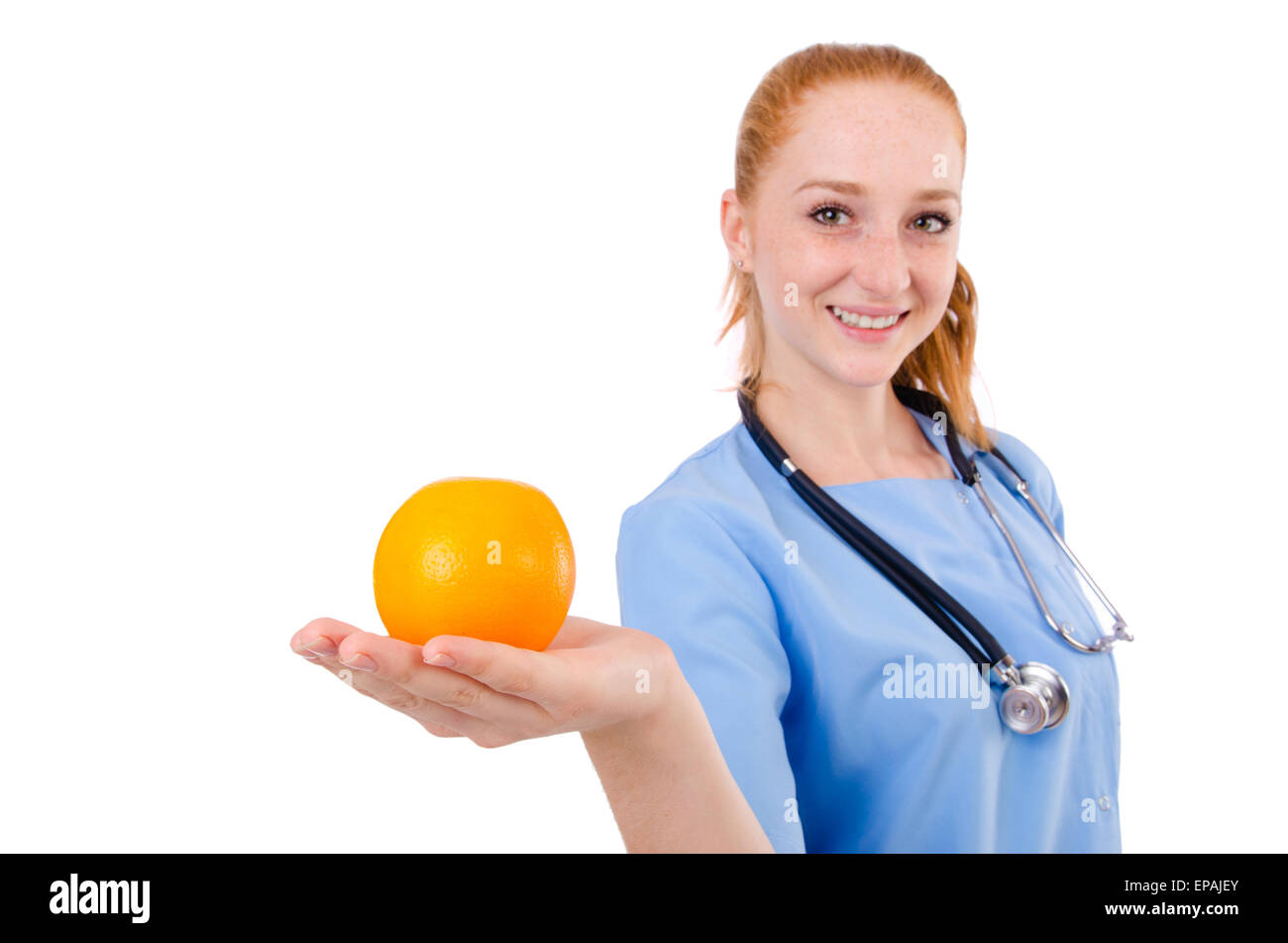 Pretty doctor in blue uniform with stetothcope and orange isolated on ...