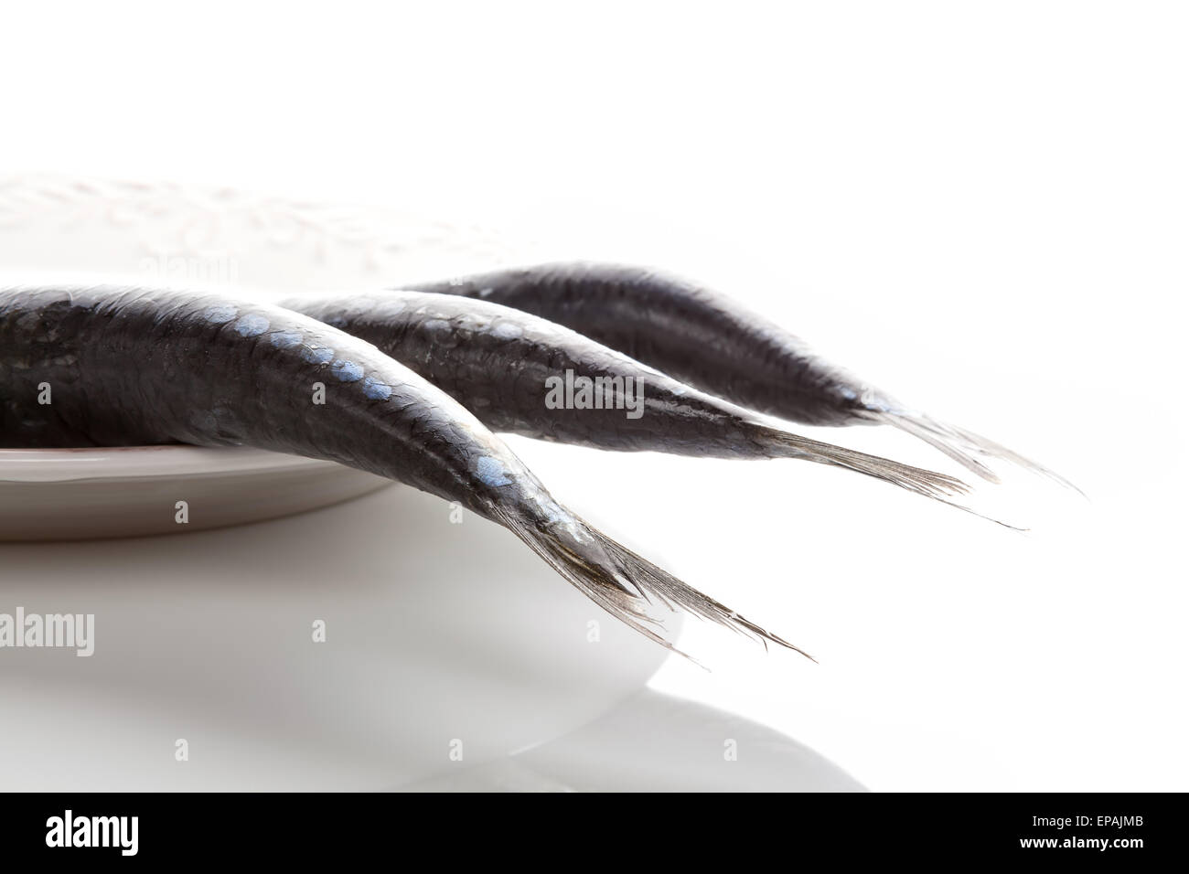 Fish tails on plate isolated on white background. Luxurious seafood ...