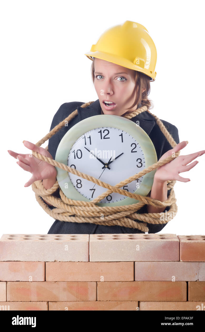 Woman construction worker with clock on white Stock Photo - Alamy