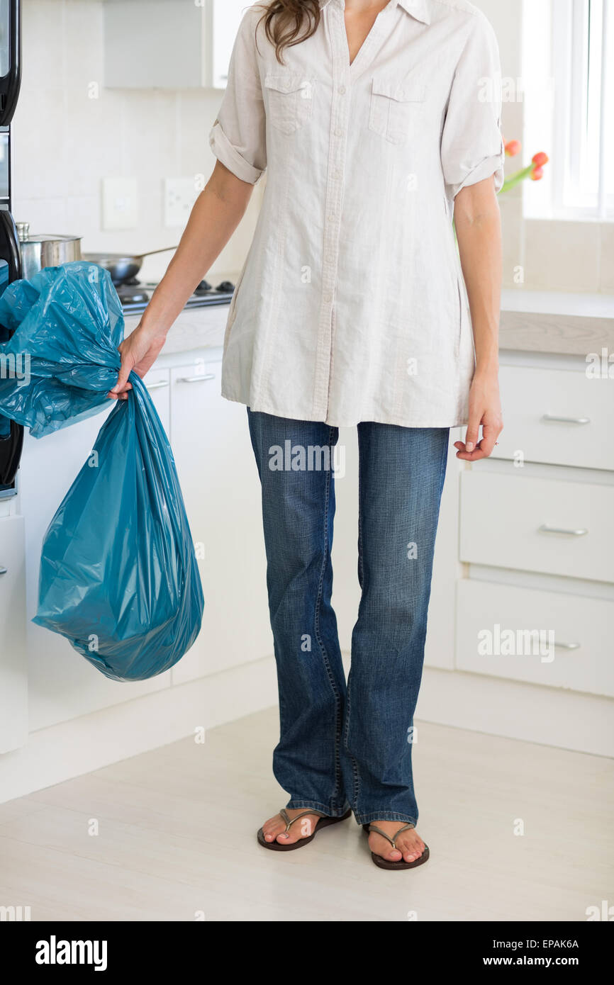 Woman carrying garbage bag hi-res stock photography and images - Alamy