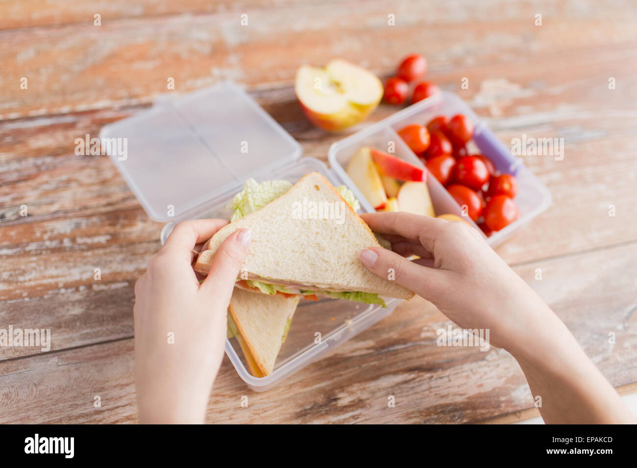 close up of woman with food in plastic container Stock Photo - Alamy