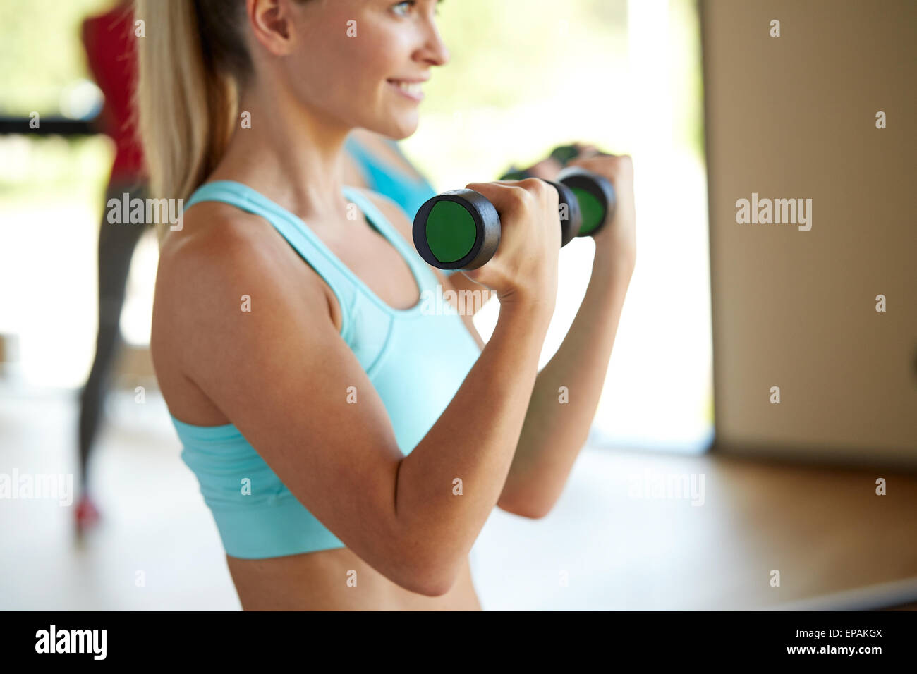 closeup of woman with dumbbells in gym Stock Photo - Alamy