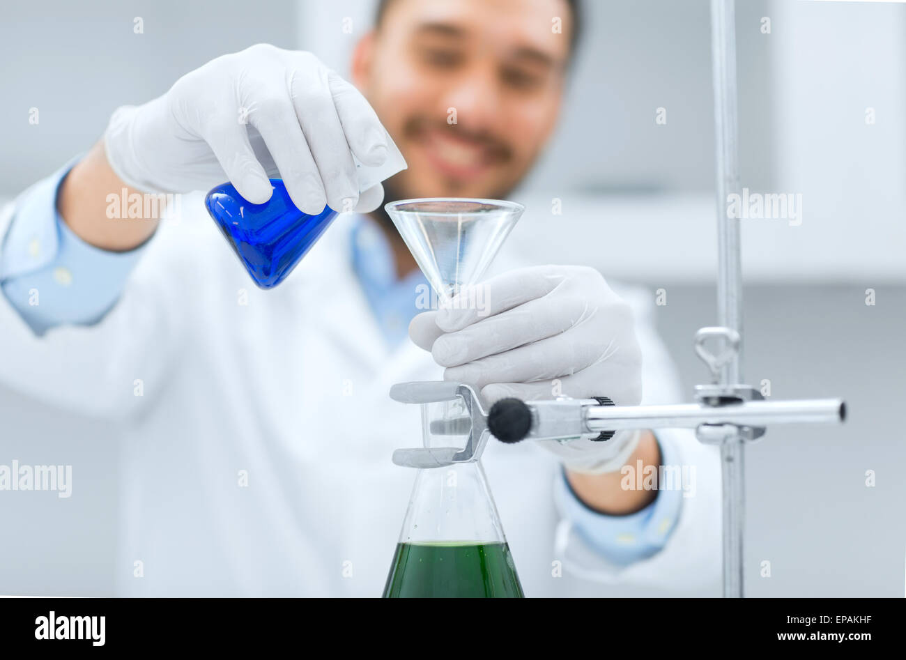 close up of scientist with test tubes and funnel Stock Photo - Alamy