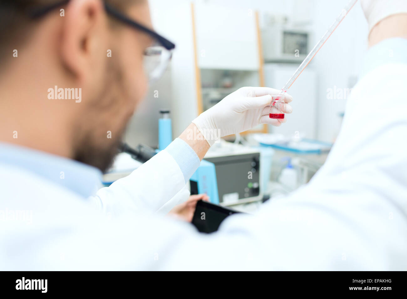 close up of scientist with tube and pipette in lab Stock Photo - Alamy
