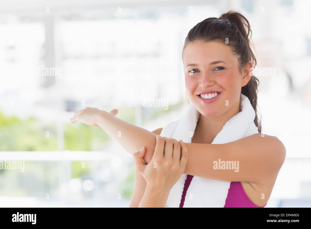 Portrait of a sporty woman stretching hand at yoga class Stock Photo ...
