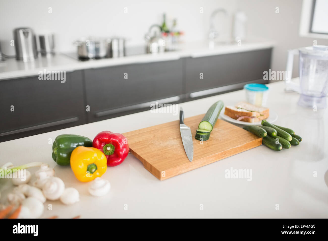 Vegetables with knife and chopping board on kitchen counter Stock Photo ...