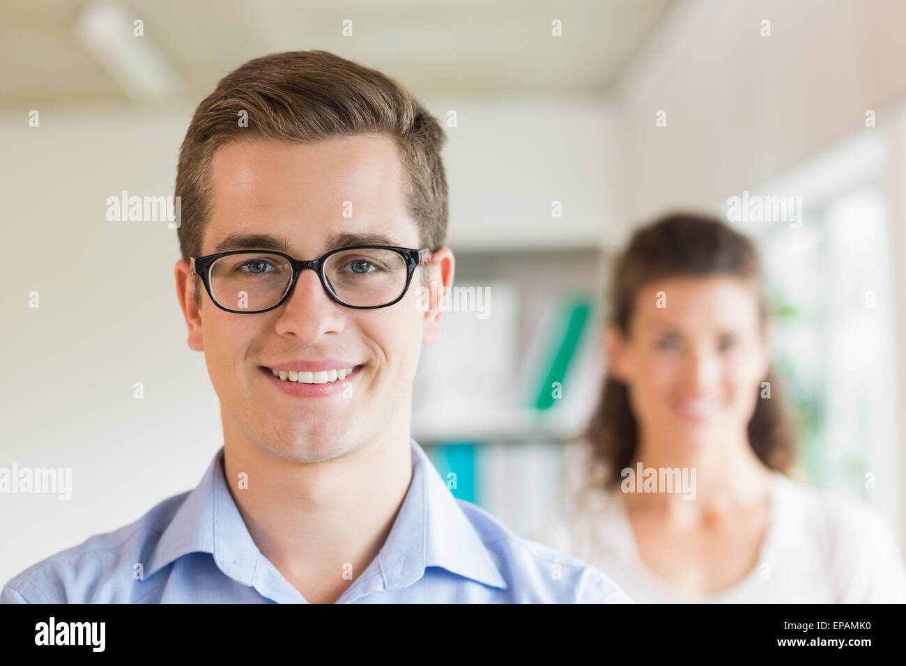 Confident businessman smiling in office Stock Photo - Alamy