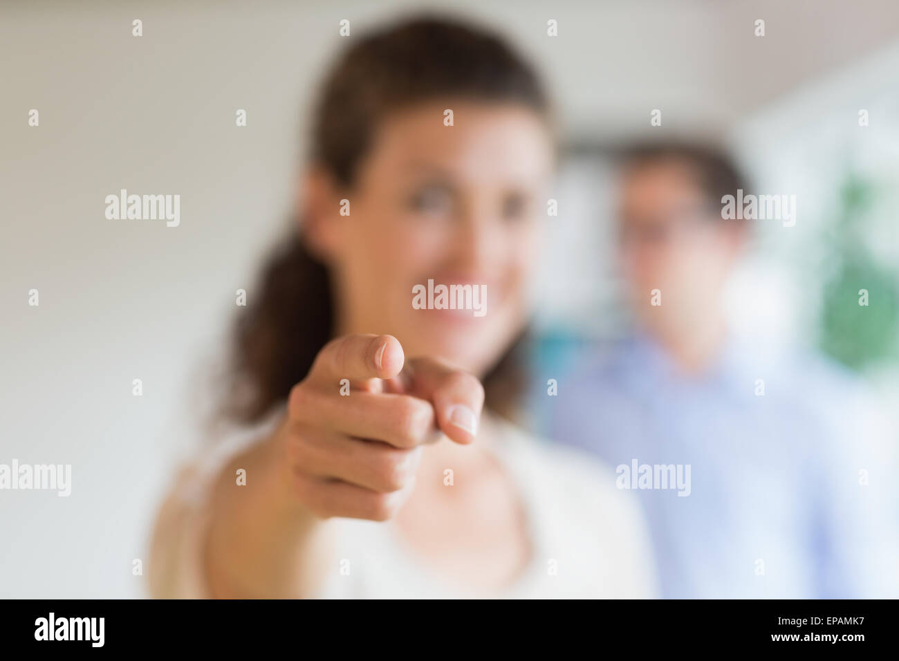 Businesswoman pointing in office Stock Photo - Alamy