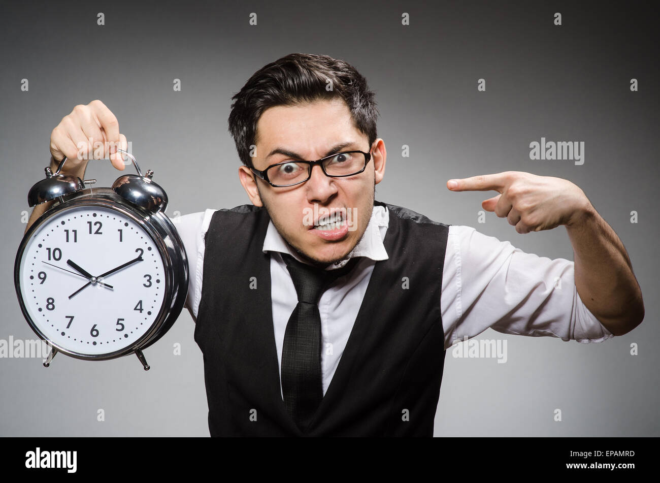 Businessman with clock in time concept Stock Photo - Alamy