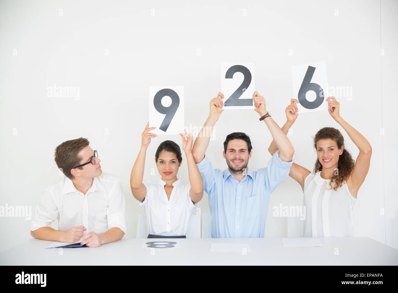 Business people holding score signs Stock Photo - Alamy