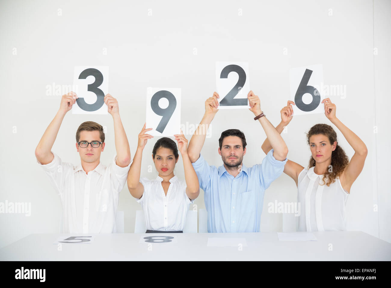 Business people holding score cards Stock Photo - Alamy