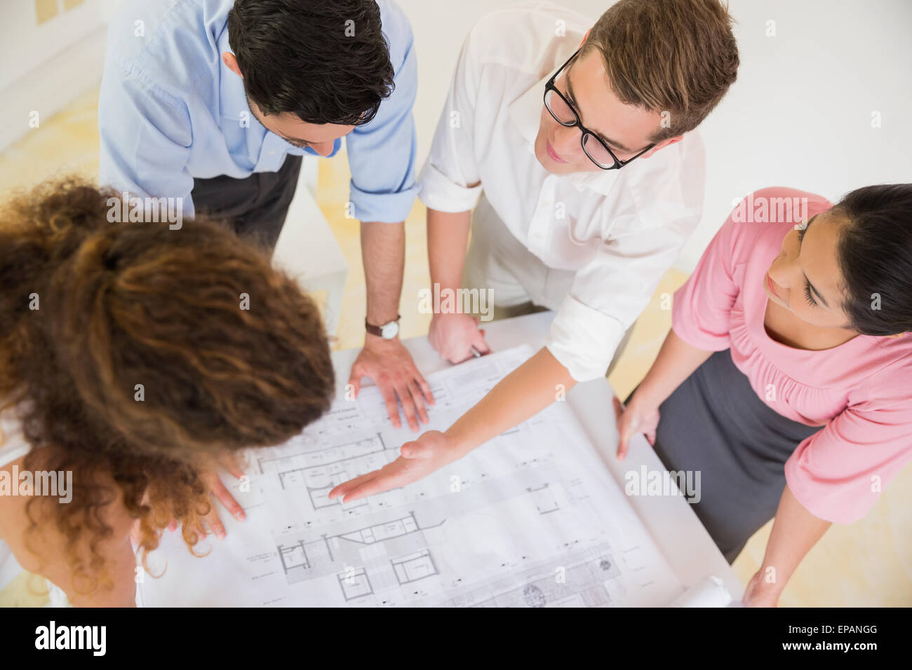 Business people discussing over blueprint Stock Photo - Alamy