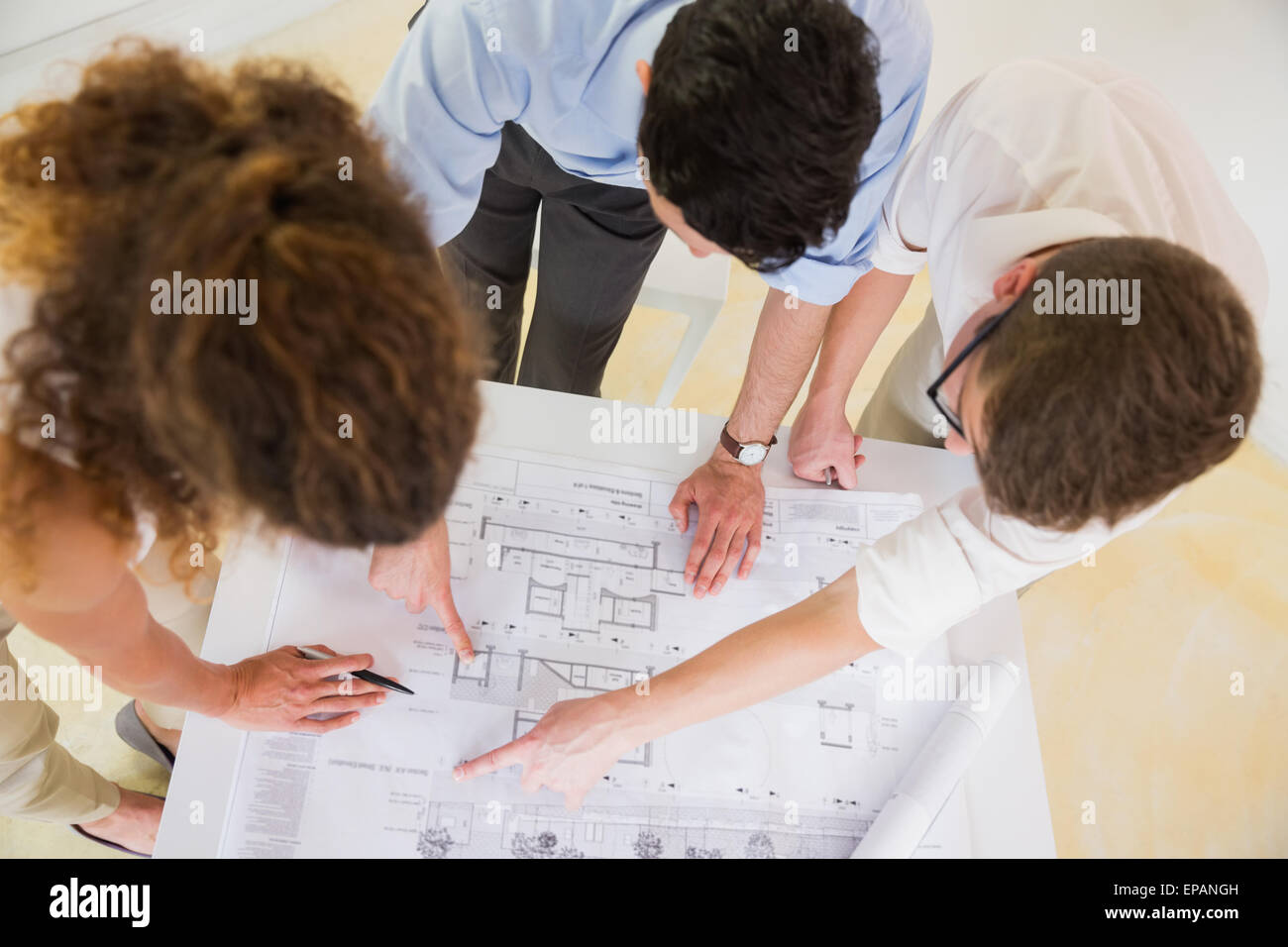Business people analyzing blueprint Stock Photo - Alamy