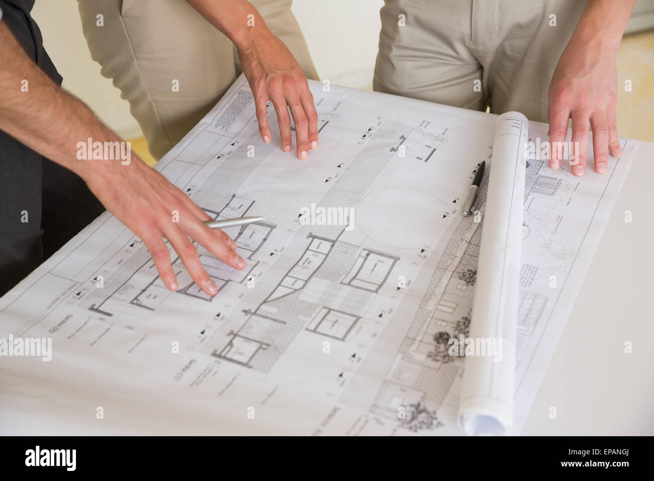 Business people wotking on blueprint Stock Photo - Alamy