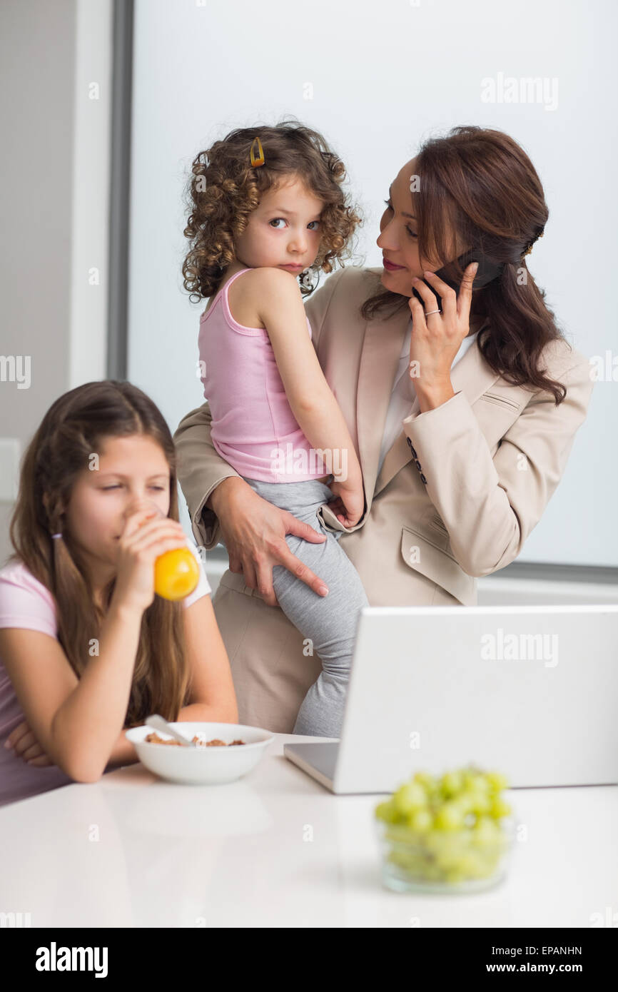 Well dressed mother with daughters and laptop Stock Photo - Alamy