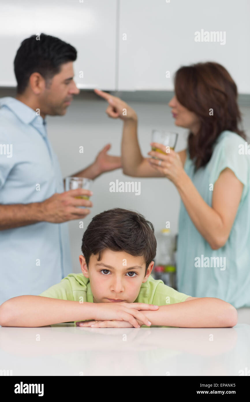 Portrait of a sad son while parents quarreling Stock Photo - Alamy