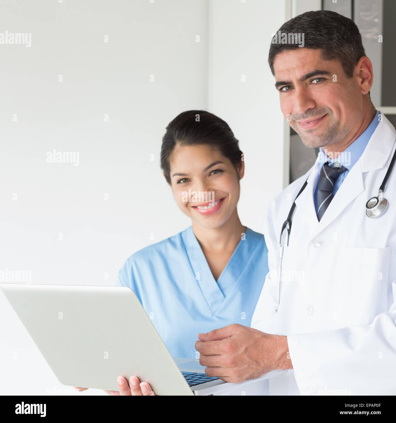 Confident doctor and nurse using laptop Stock Photo - Alamy