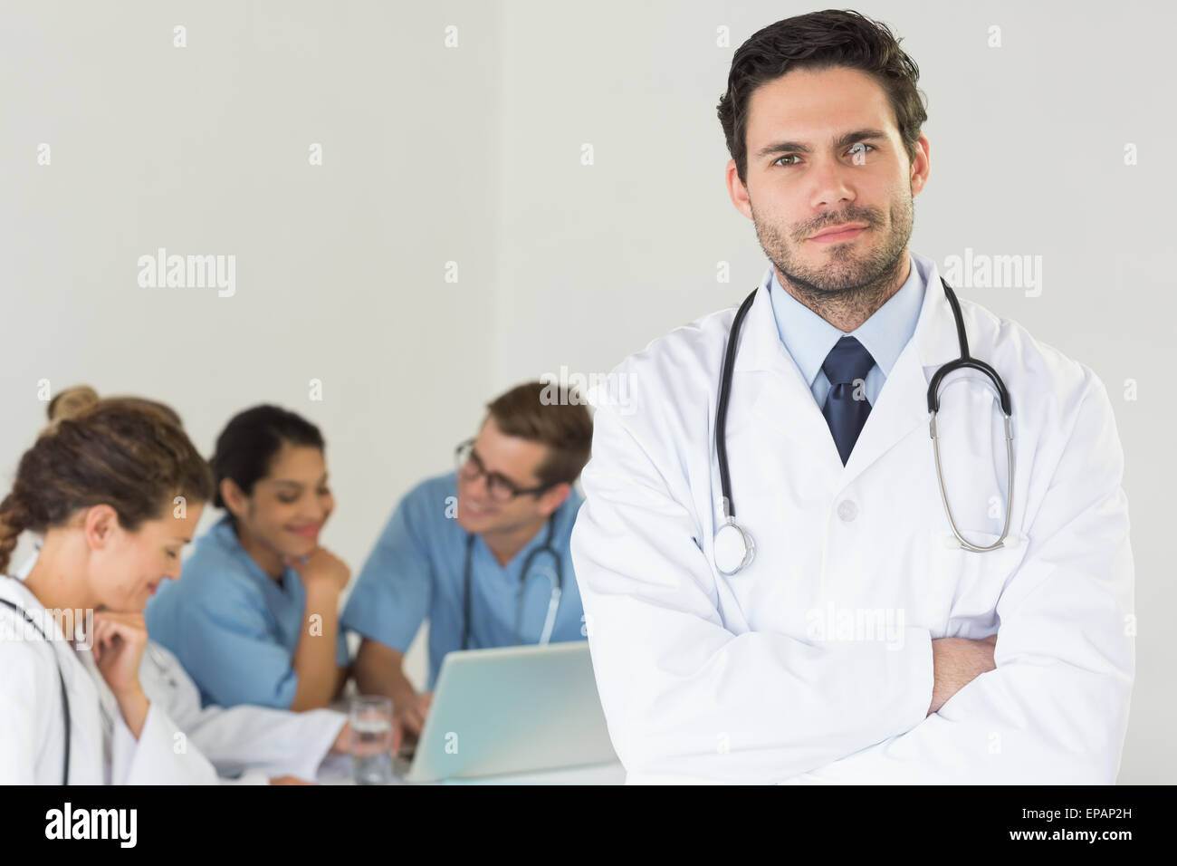 Male doctor standing arms crossed Stock Photo - Alamy