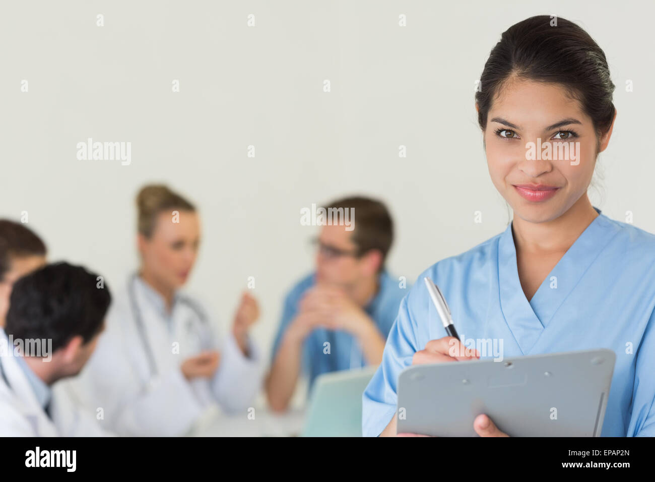 Female nurse writing on clipboard Stock Photo - Alamy