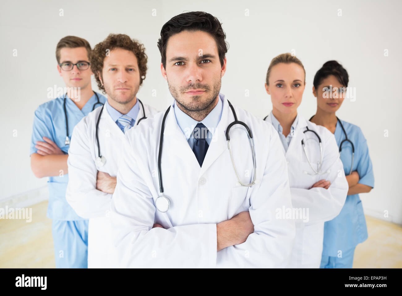 Medical team standing arms crossed Stock Photo - Alamy