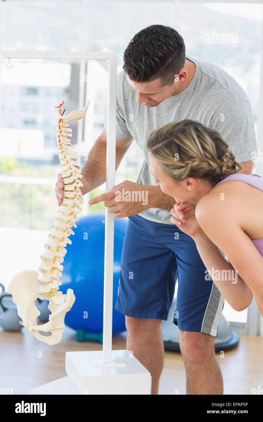 Instructor pointing on bone in the spine to woman Stock Photo - Alamy