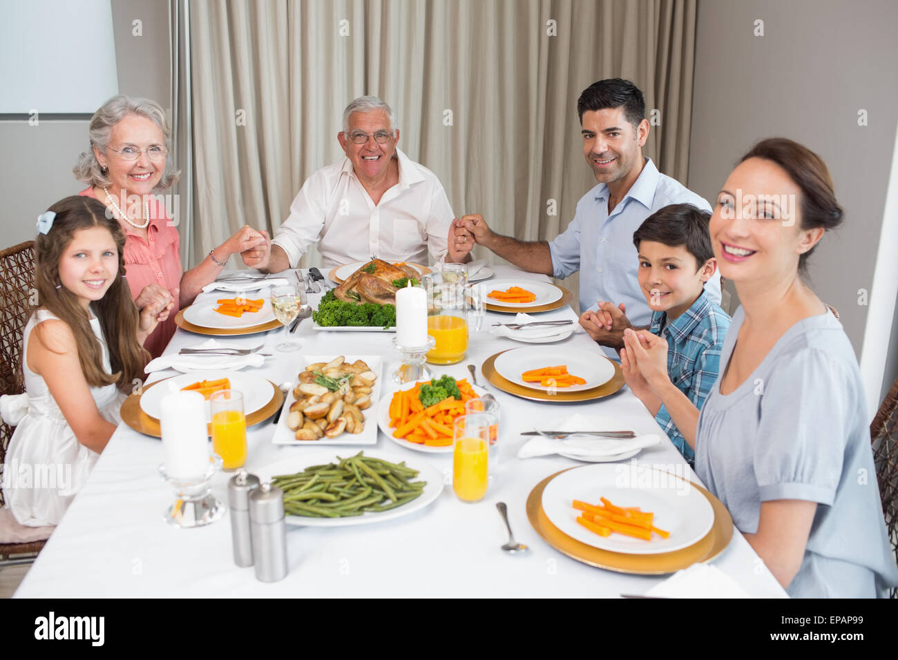 Portrait of an extended family at dining table Stock Photo - Alamy