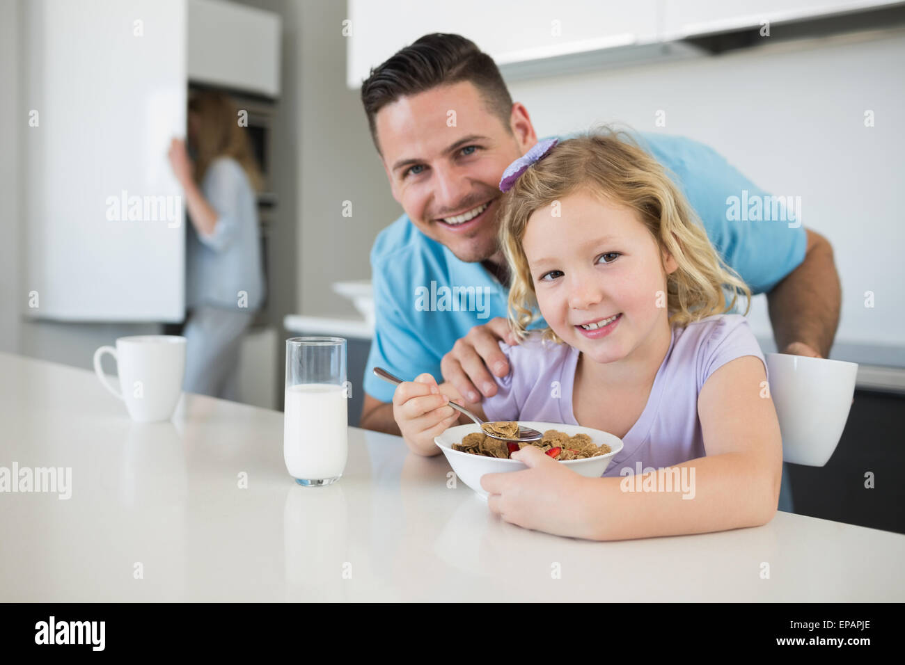 Father and daughter at breakfast table in house Stock Photo - Alamy